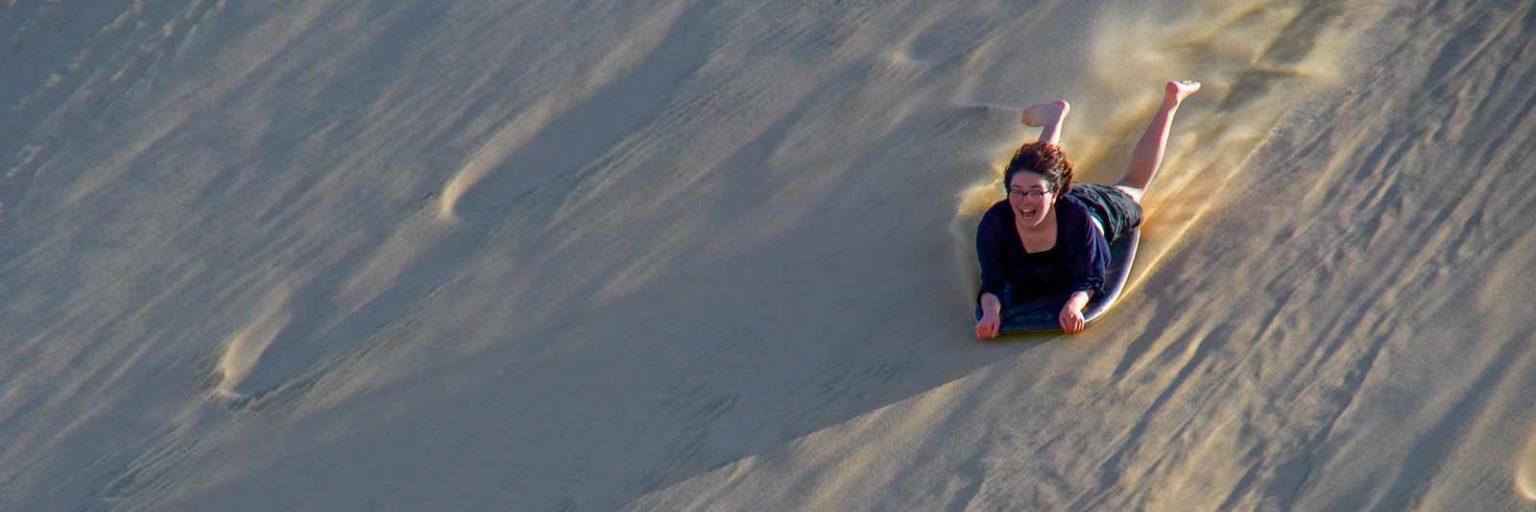 Sandboarding at Te Paki Sand Dunes, New Zealand • Albom Adventures