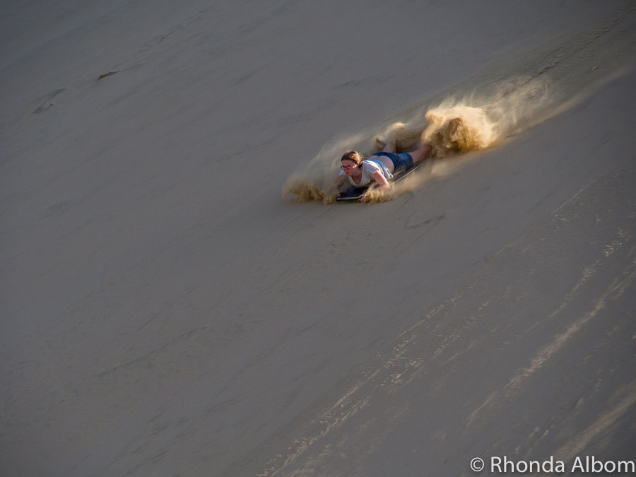 Sandboarding at Te Paki Sand Dunes, New Zealand